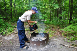 What is the safest way to extinguish a campfire?